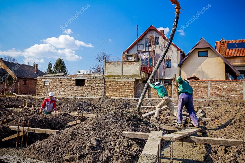 Team of construction workers are working on concreting at constr ...