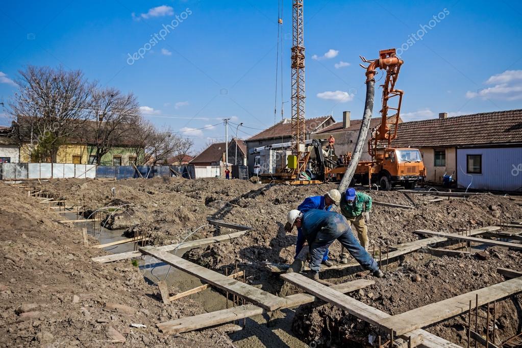 Team of construction workers are working on concreting at constr ...