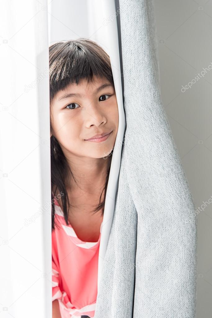 Asian girl hiding Stock Photo by ©Jayjaynaenae 85314348