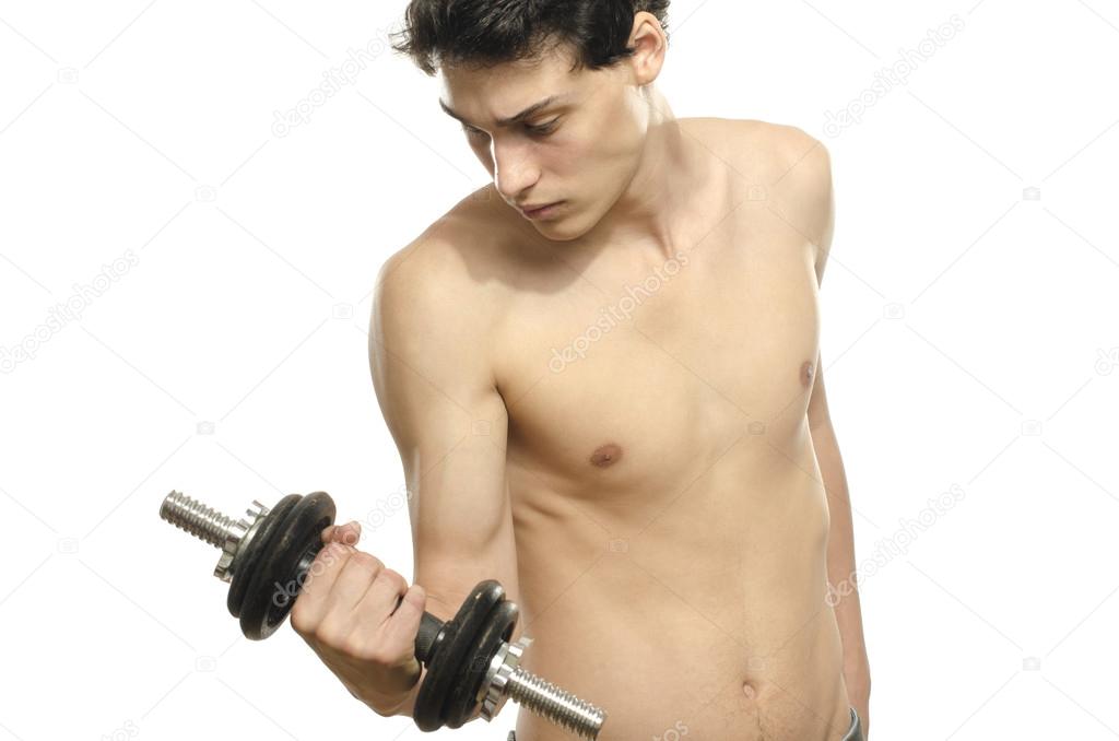 Skinny man training his bicep muscle. Beautiful teenager lifting a ...