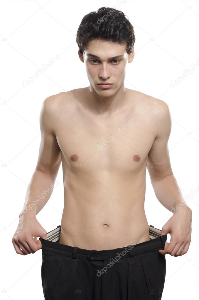 Skinny young man with large pants,anorexic look, slim body. Man lost ...