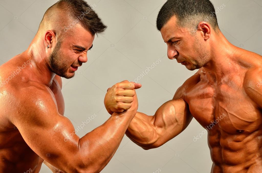 Strong bodybuilders testing their biceps in a skandemberg contes ...