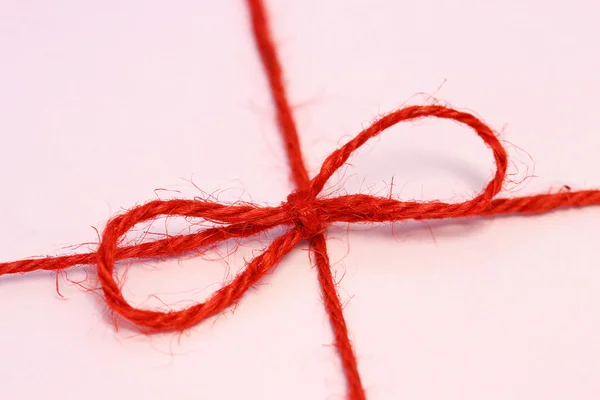 String tied in a bow on white Stock Photo by ©bennyartist 36511653