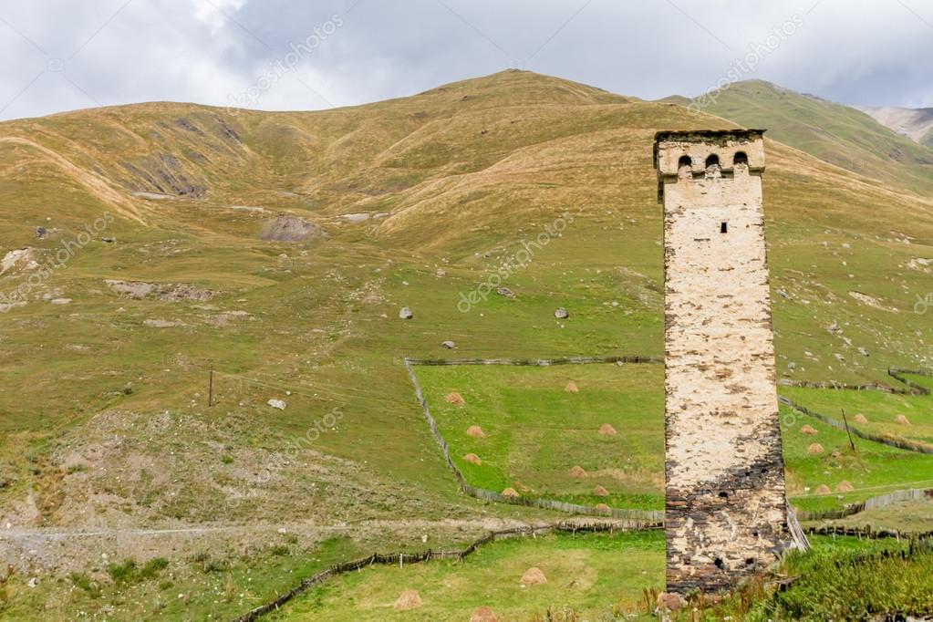 Ancient stone tower in Georgia, mountain background Stock Photo by ...