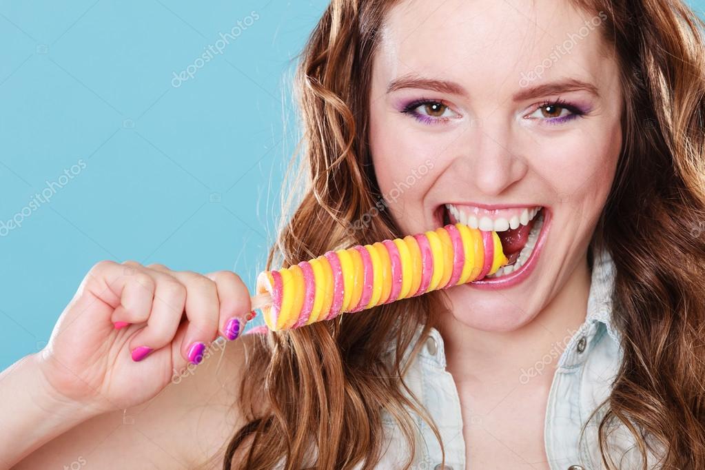 Woman eating popsicle ice pop Stock Photo by ©Voyagerix 103489318