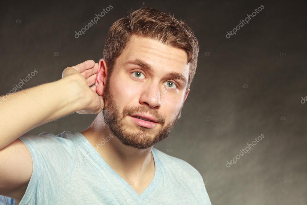 Gossip man eavesdropping with hand to ear. Stock Photo by ©Voyagerix ...