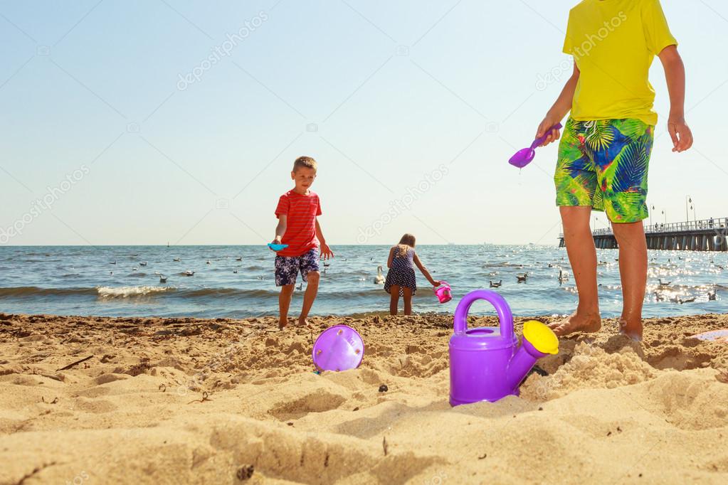 Kids playing outdoor on beach. Stock Photo by ©Voyagerix 111928042