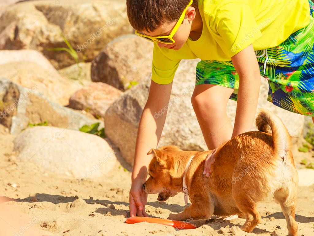 Boy playing with his dog. — Stock Photo © Voyagerix #112360038