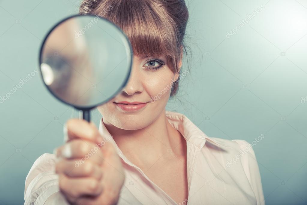 Woman holding magnifying glas — Stock Photo © Voyagerix #112647586