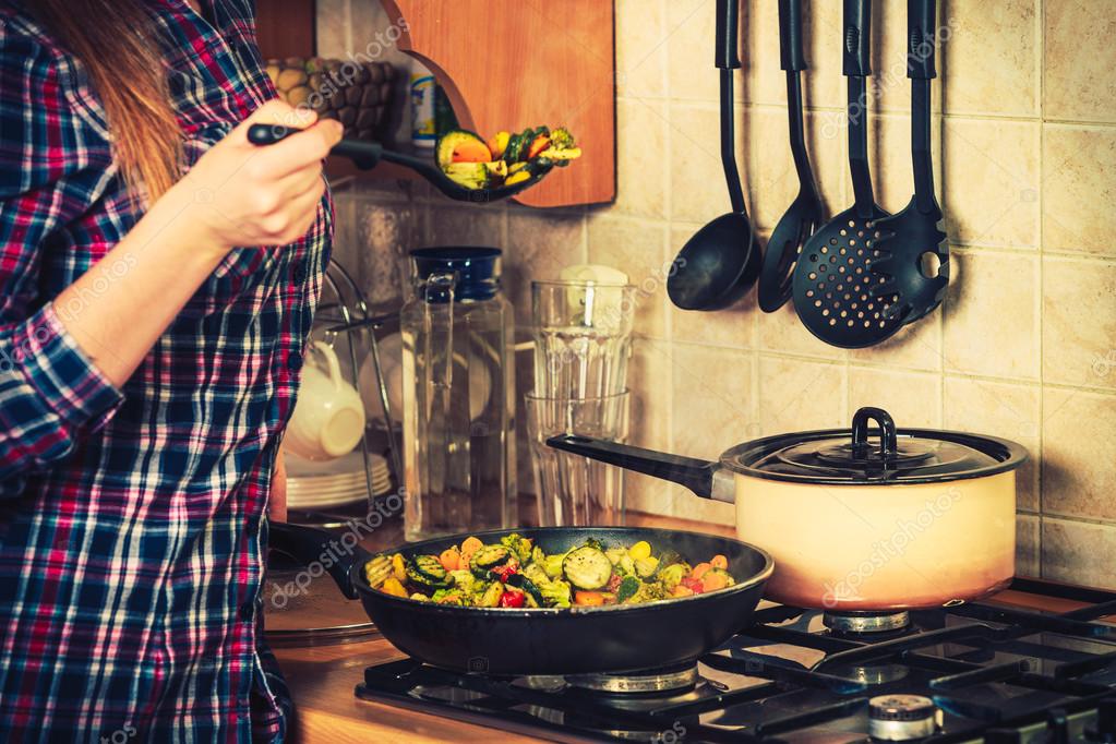 Human frying frozen vegetables. Stir fry. Stock Photo by ©Voyagerix ...