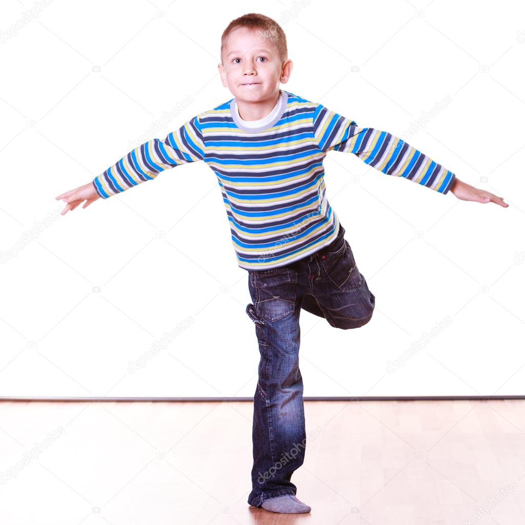 Little boy have fun alone at home stand on one leg. — Stock Photo ...