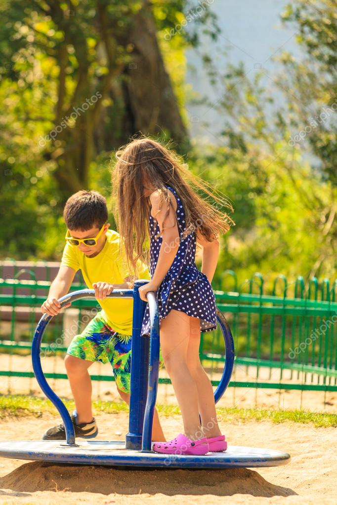 Kids having fun on playground. Stock Photo by ©Voyagerix 120879646