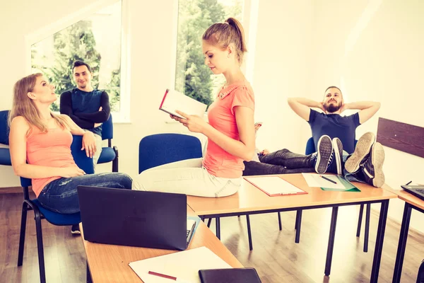 Students in classroom during the break Stock Photo by ©Voyagerix 191940272
