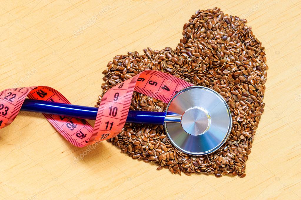 Flax seeds heart shaped and stethoscope Stock Photo by ©Voyagerix 55928171