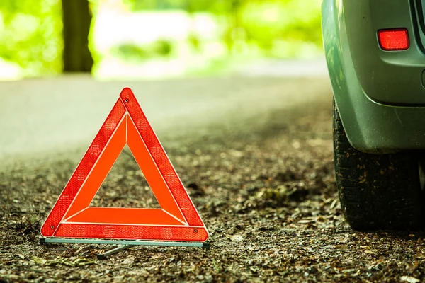 Red warning triangle sign on road — Stock Photo © Voyagerix #48822503