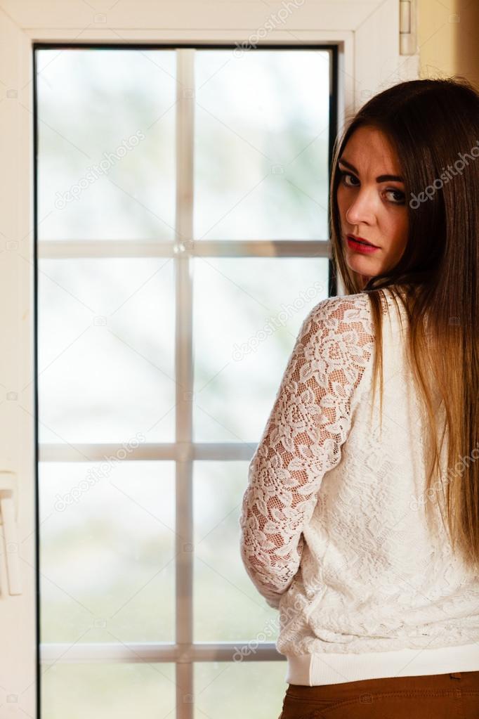 Woman looking through window. Stock Photo by ©Voyagerix 68882525