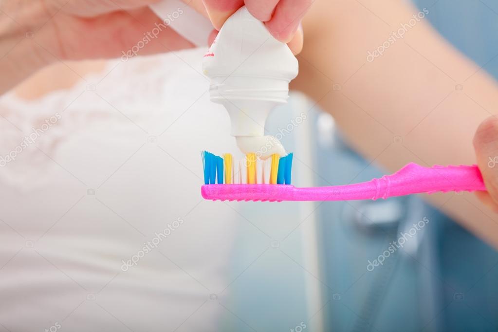 Putting Toothpaste On Toothbrush