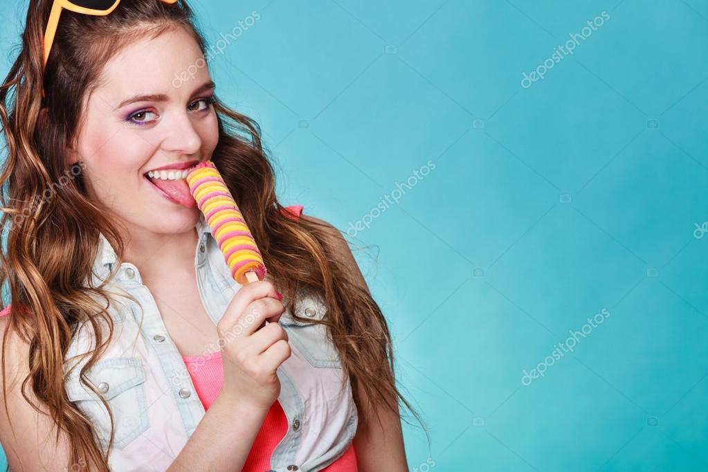 Woman eating popsicle ice pop cream Stock Photo by ©Voyagerix 72975903