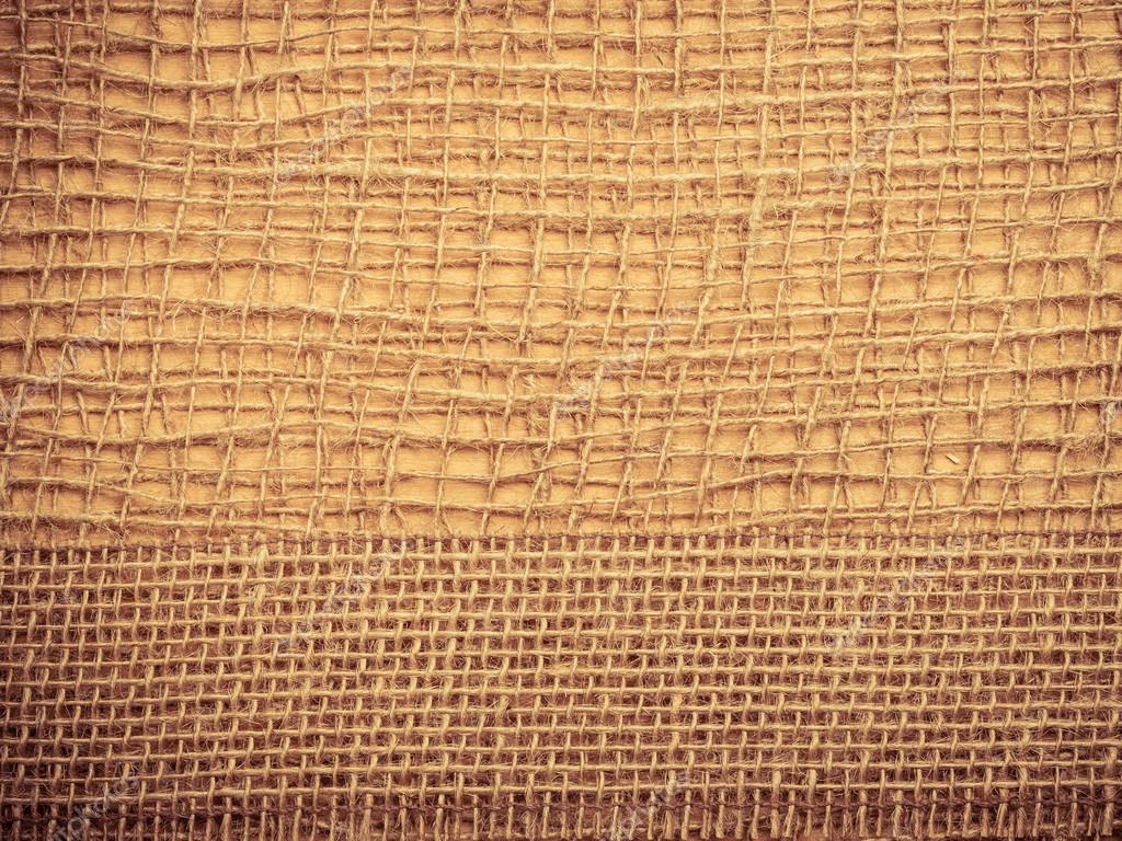 Jute ribbon on burlap cloth background — Stock Photo © Voyagerix #75363349