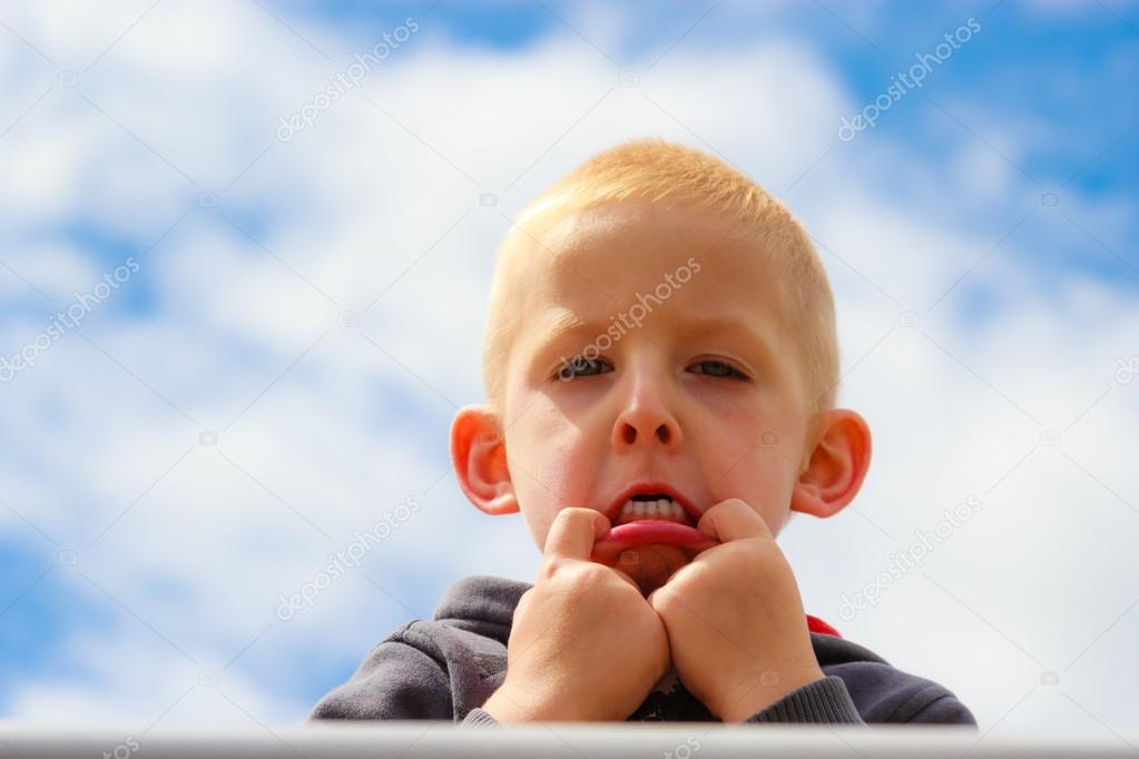 Child kid making silly face Stock Photo by ©Voyagerix 79644172