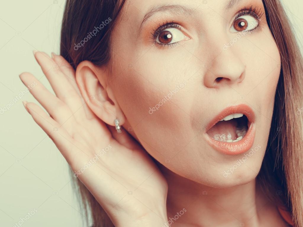 Girl eavesdropping with hand to ear Stock Photo by ©Voyagerix 80327802