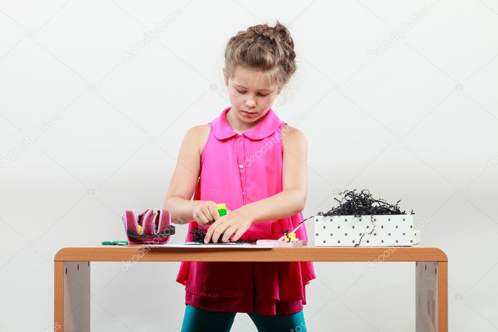 Girl creating composition Stock Photo by ©Voyagerix 83176252