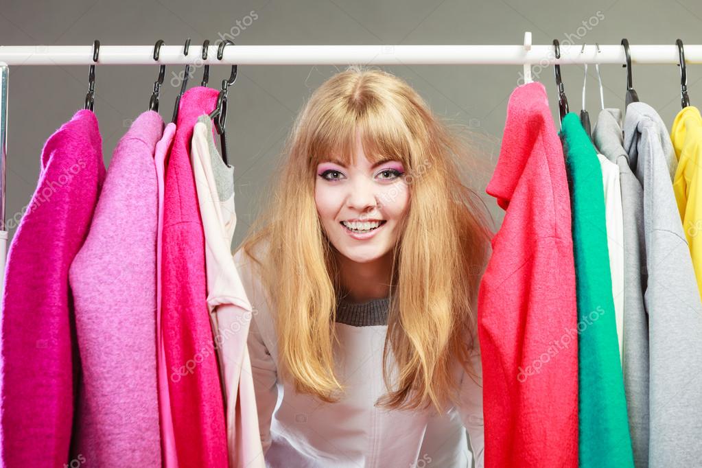 Pretty woman between new clothes. Stock Photo by ©Voyagerix 91210708