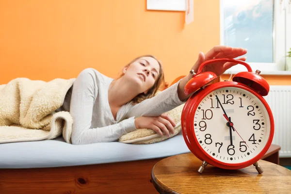 Woman turning off alarm clock - Stock Image - Everypixel