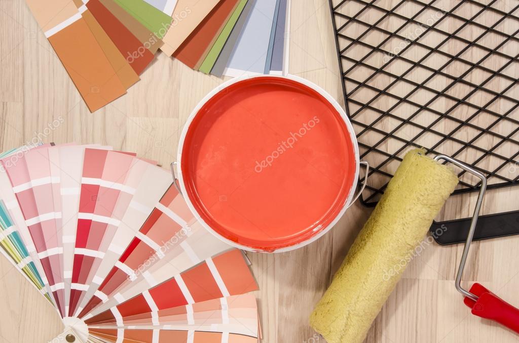 Coral red paint can. Samples with different shades of red and can of ...