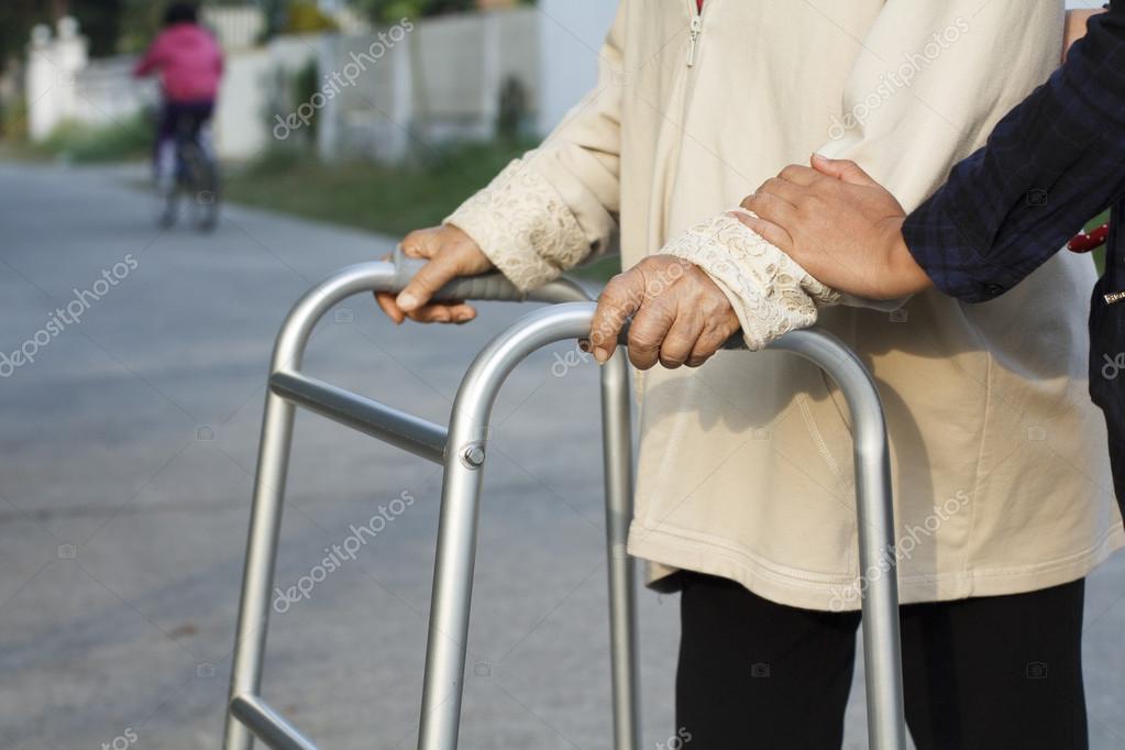 Senior woman using a walker cross street — Stock Photo © toa55 #64352717