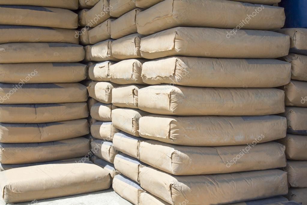 Cement bags stacked in warehouse Stock Photo by ©toa55 92314014