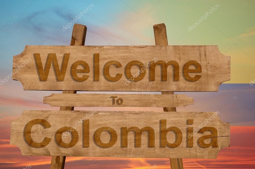 Welcome to Colombia sing on wood background with blending national flag ...