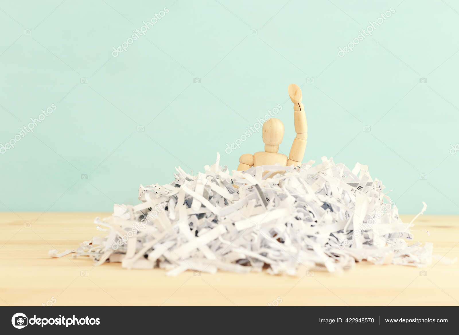 Wooden Dummy Drowning Shredded Paper Stock Photo by ©tomert 422948570