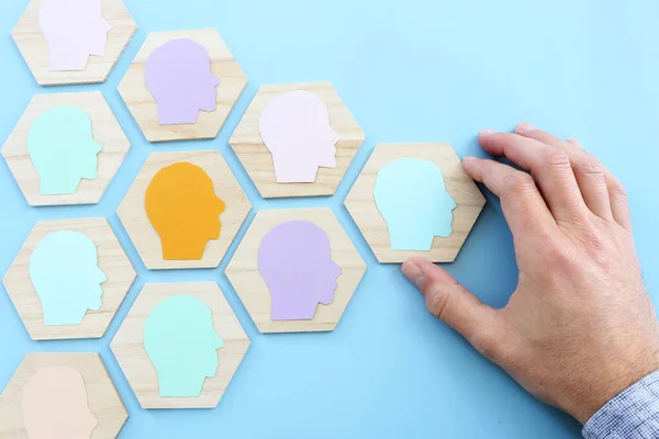 wooden blocks with people icon over blue background, building a strong ...