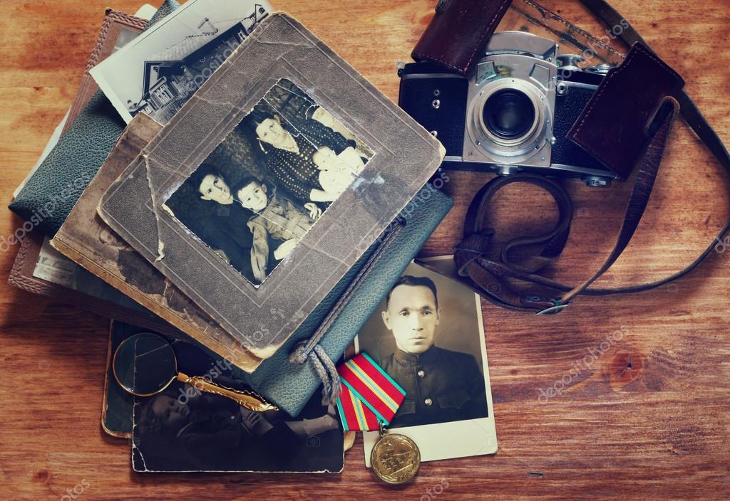 Top view of vintage camera, old pictures and war madal. historic ...