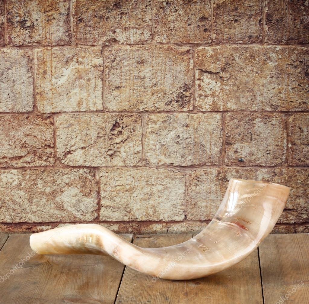 Shofar (horn) on wooden table. rosh hashanah (jewish holiday) concept ...