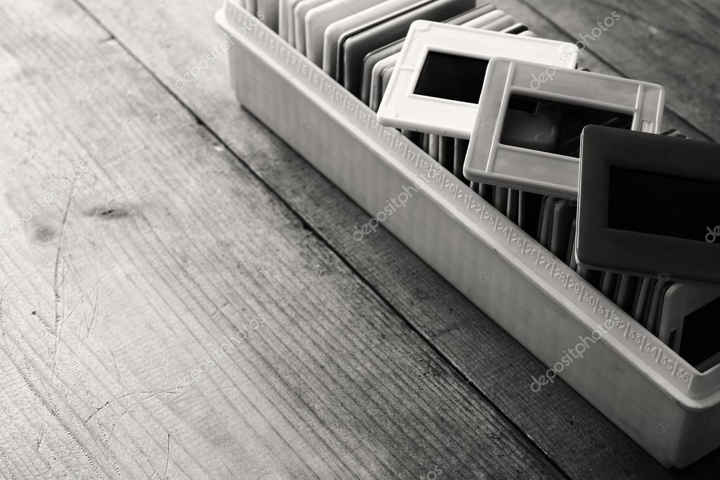 Black and white close up image of old slides frames and old camera over ...