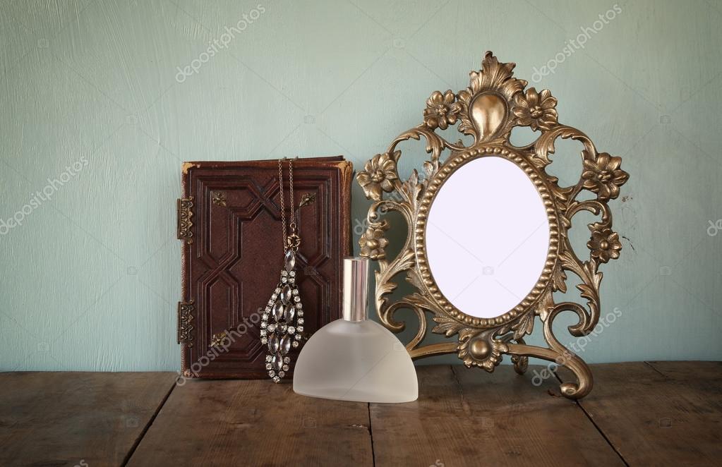Antique blank Victorian style frame and old book with vintage necklace ...
