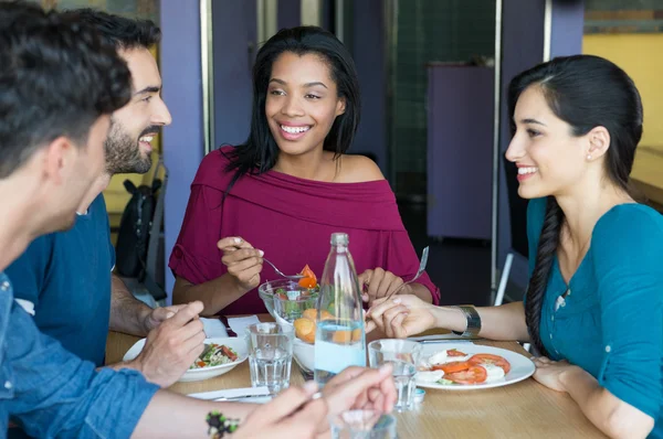 Smiling friends eating together - Stock Image - Everypixel