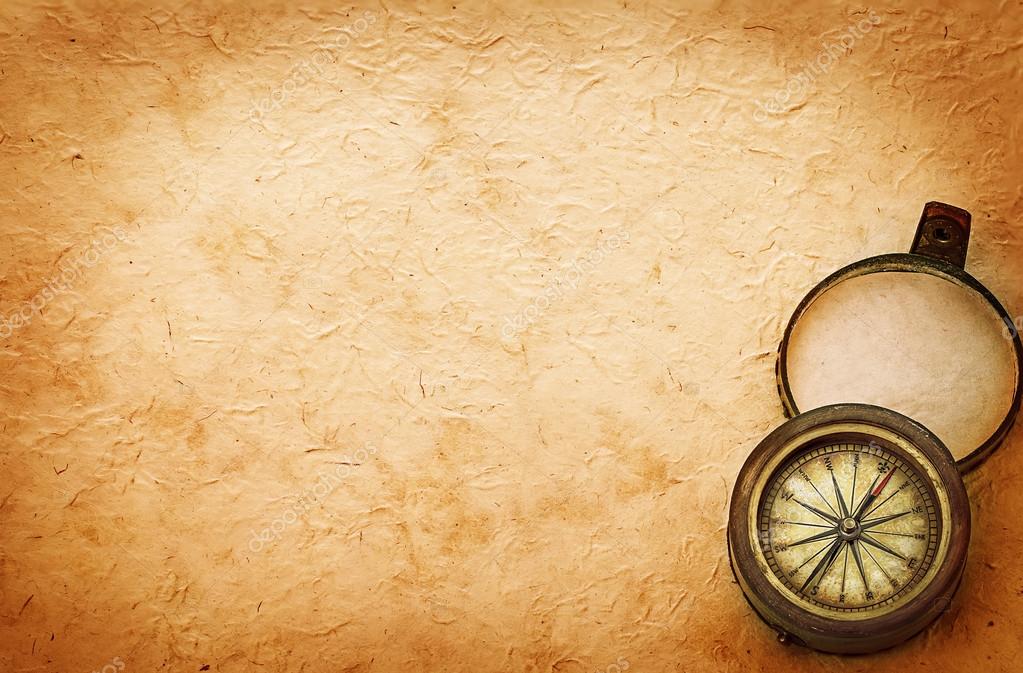 Ancient brass compass on vintage old paper background. Retro stale. ⬇ ...