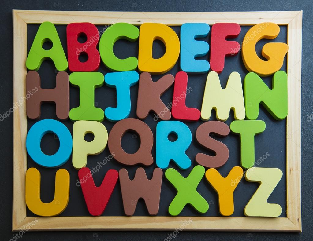 Colorful wooden alphabet on black board Stock Illustration by ...