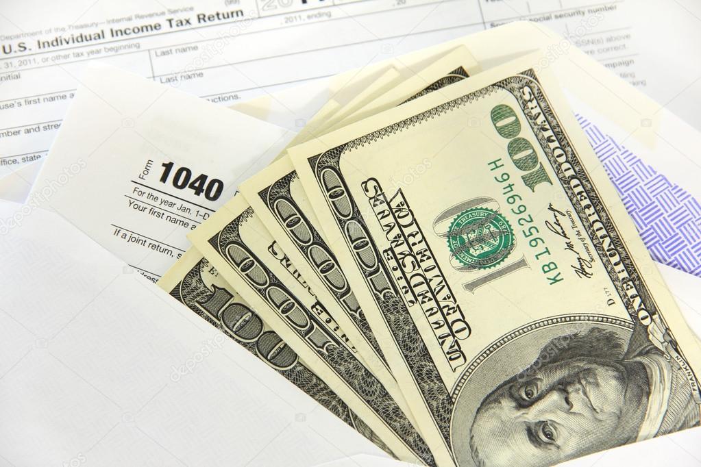 Tax forms with dollar bills Stock Photo by ©PTstock 64343749