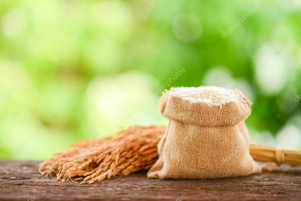 White rice in burlap sack with rice grain Stock Photo by ©antpkr 120806008
