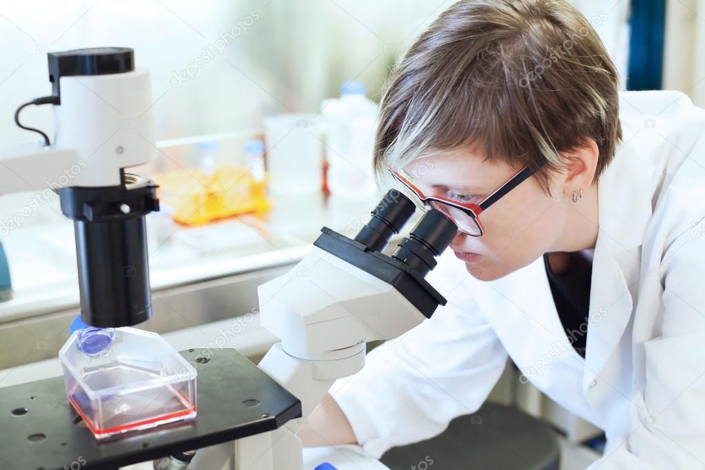 Scientist looking at microscope Stock Photo by ©anyaberkut 88318116