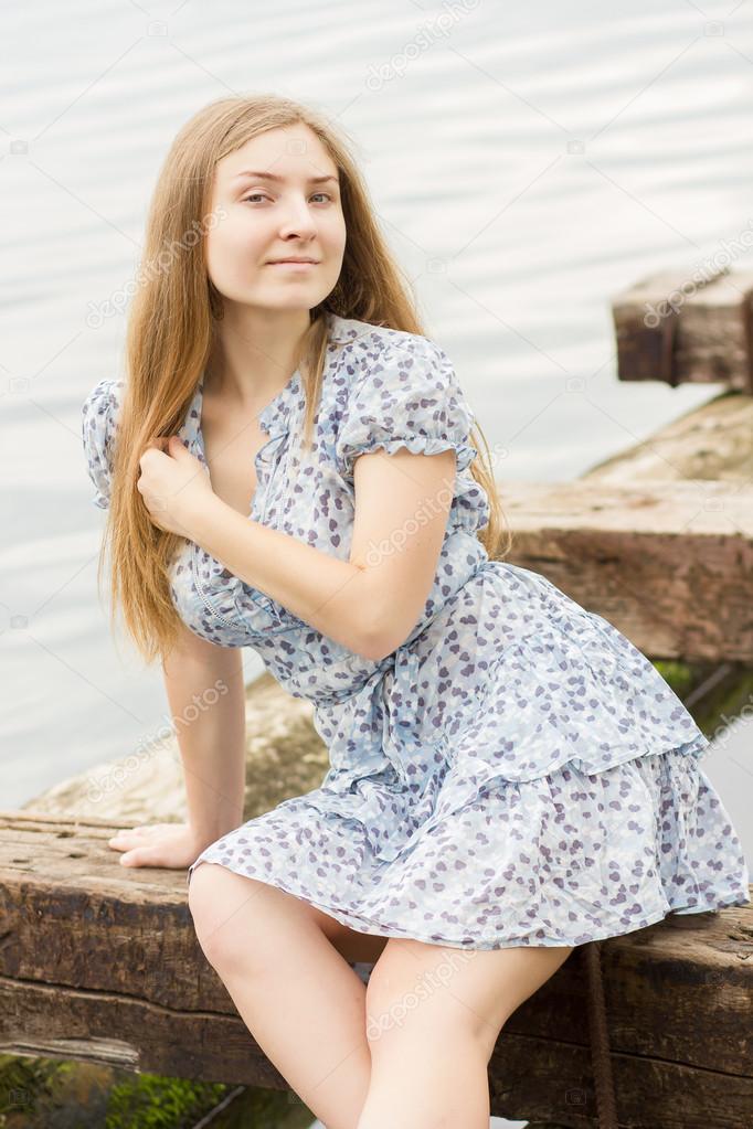 Portrait Of A Beautiful Young Woman With Long Brown Hair In A Short