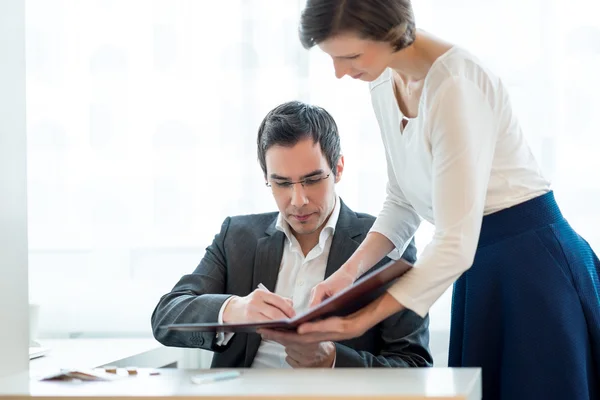 Secretary presenting a document for signature - Stock Image - Everypixel