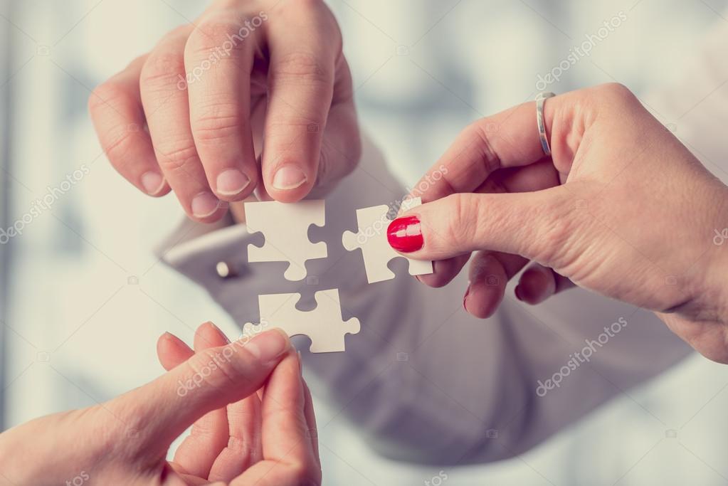 Different people matching three puzzle pieces — Stock Photo © Gajus ...
