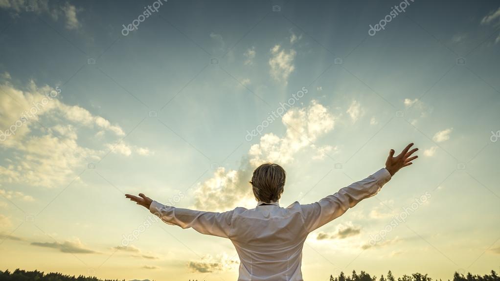 Successful man in elegant white shirt standing with his back to Stock ...