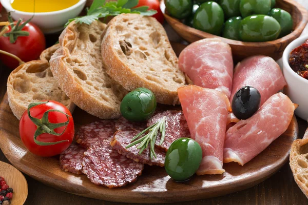 assorted Italian antipasti - deli meats, olives and bread - Stock Image ...
