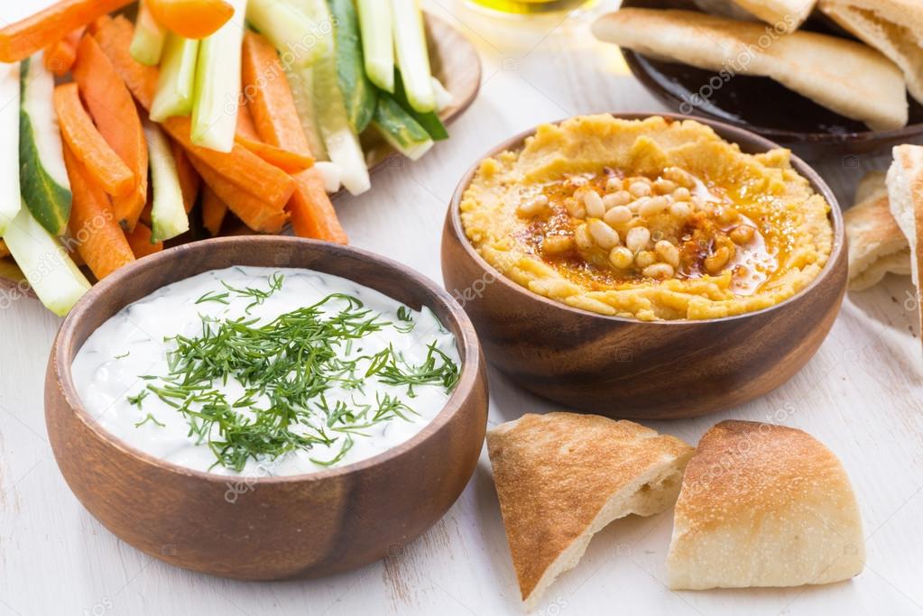 Traditional Arabic sauce - hummus and yogurt with herbs on woode Stock ...